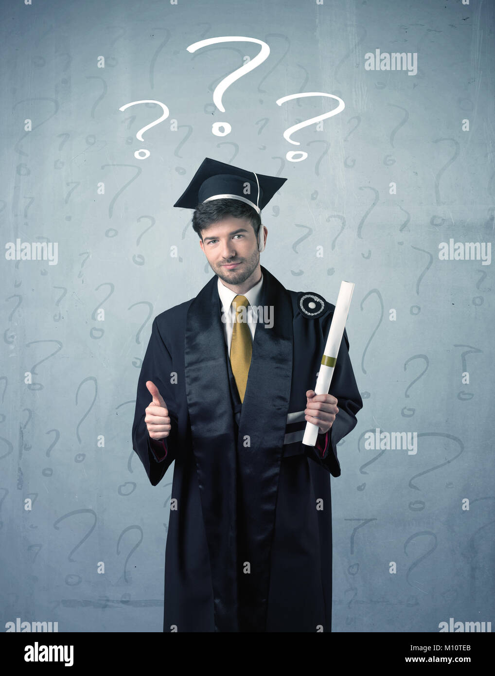 Young graduate teenager with question marks drawn over his head Stock ...