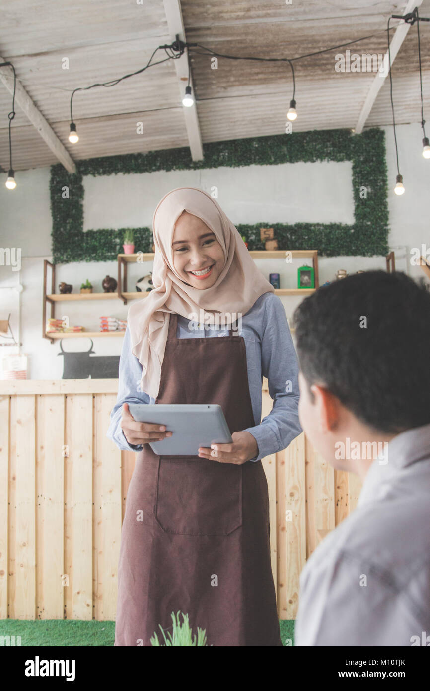 customer ordering food toward waitress at the restaurant Stock Photo ...