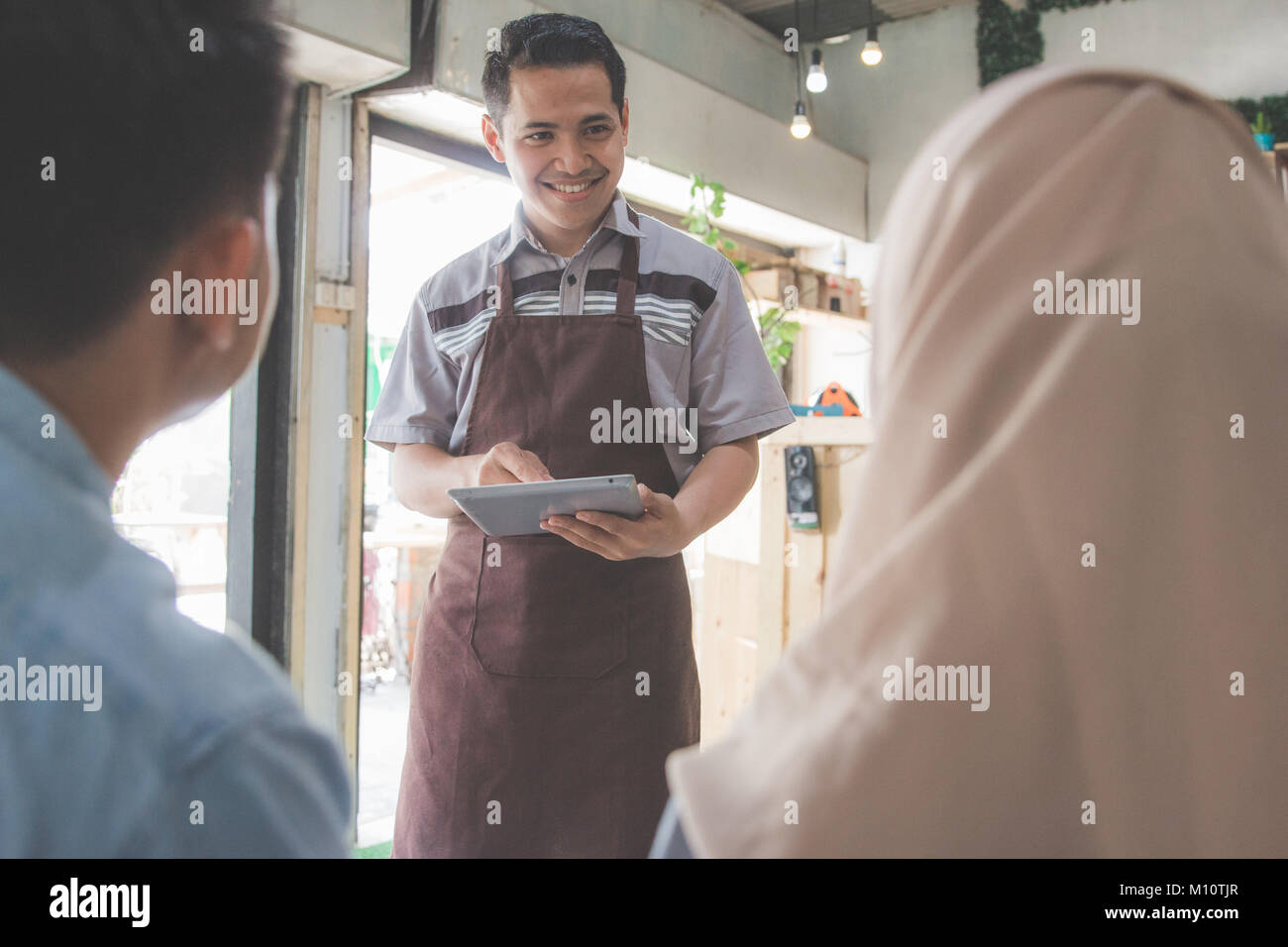 customer ordering food toward waitress at the restaurant Stock Photo ...