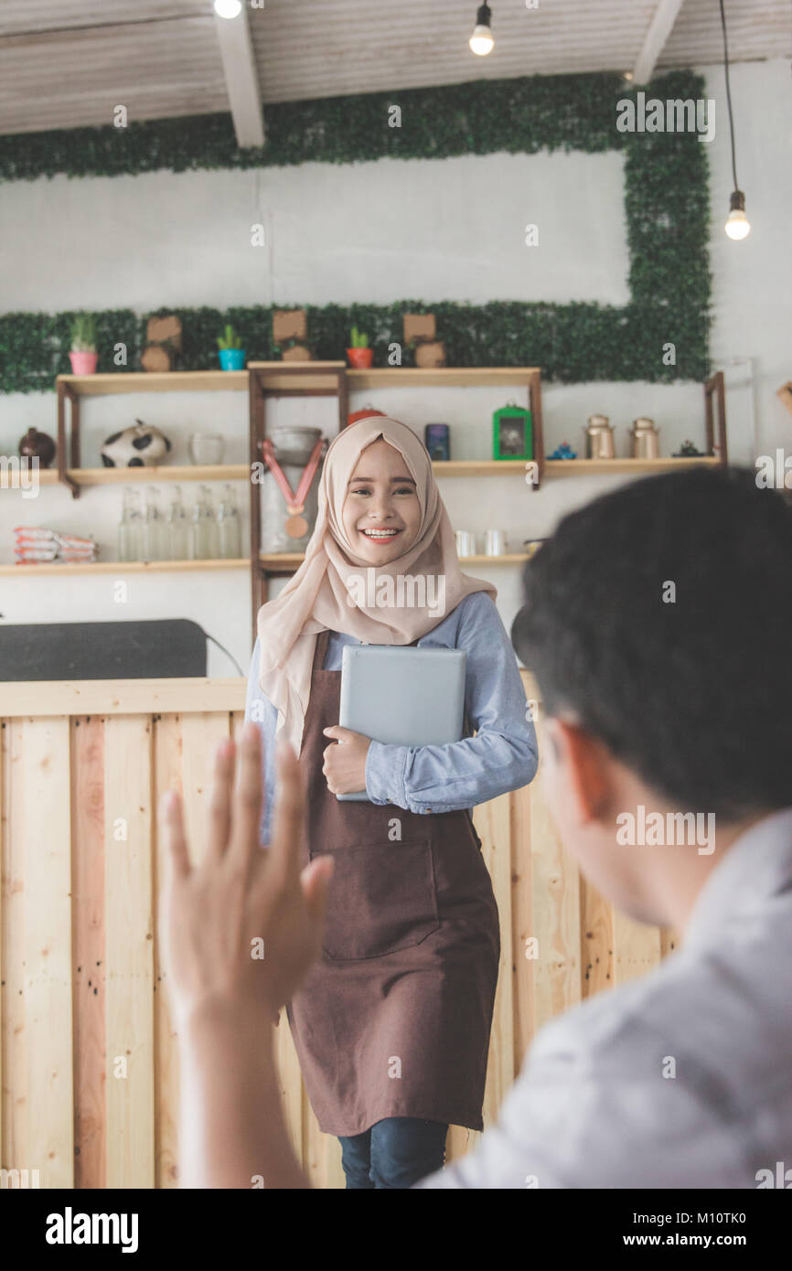 man is calling the waiter in cafe. He is raising his arm Stock Photo ...