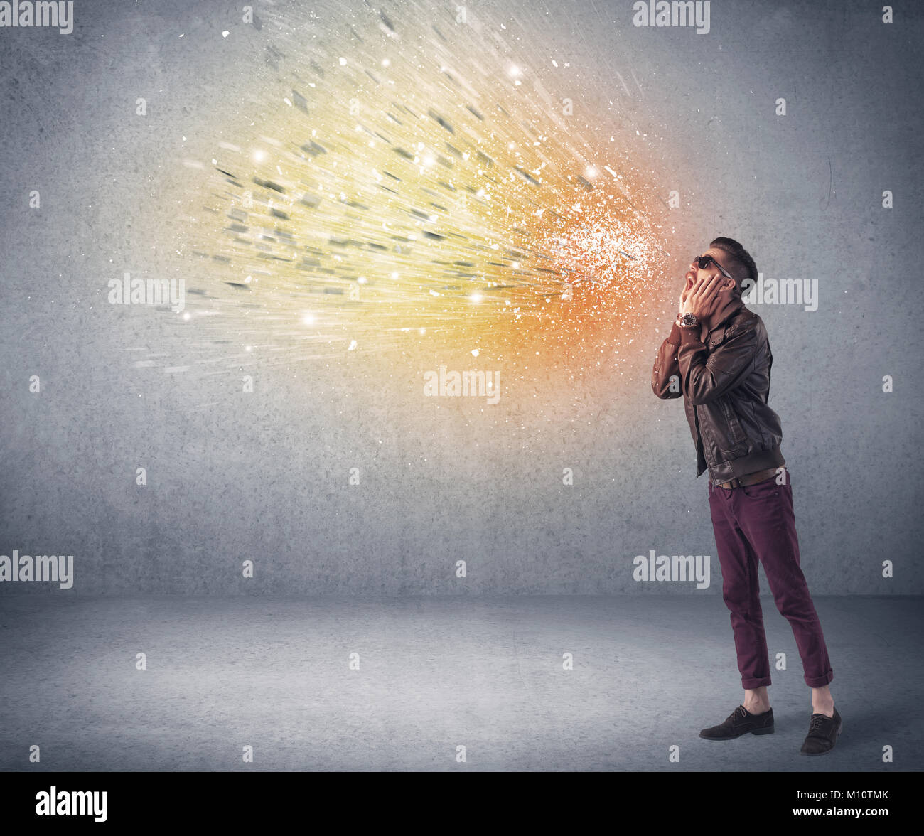 A young hipster guy with beard and sunglasses shouting in front of ...