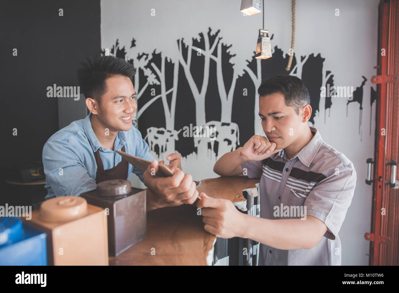 portrait of male customer ordering coffee at the cafe Stock Photo - Alamy