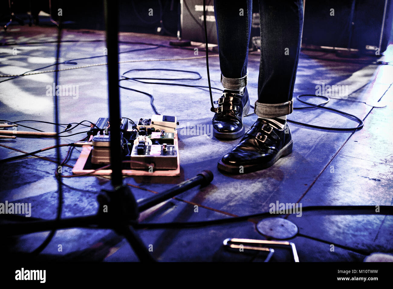 Musician on stage with shiny shoes and effect units. Denmark 2012 Stock ...