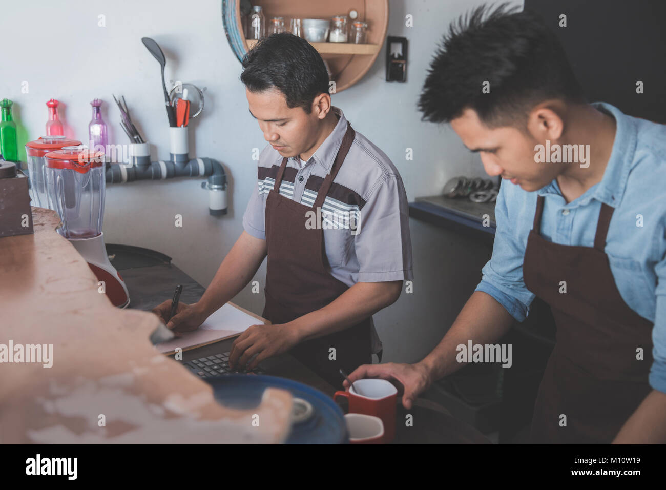 portrait of two male waiter preparing menu for customer Stock Photo - Alamy