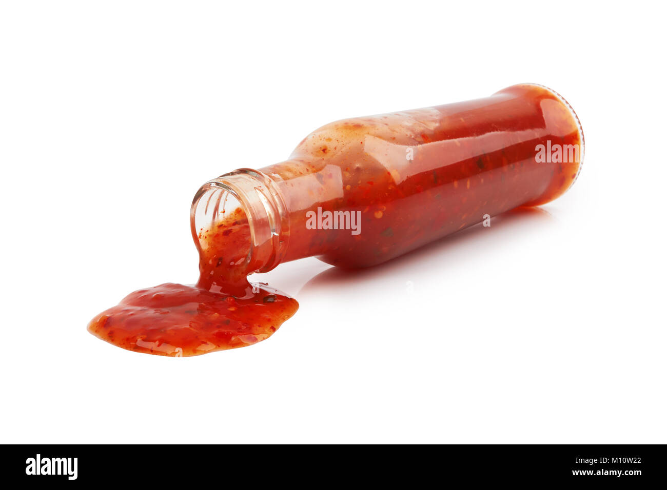bottle of hot sauce is spilling liquid on white background Stock Photo ...