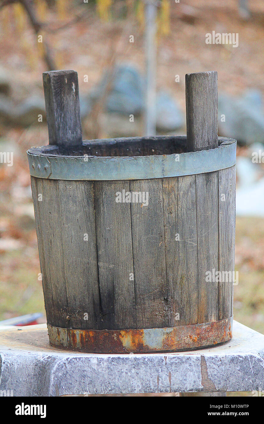 a wood bucket on the stone Stock Photo - Alamy