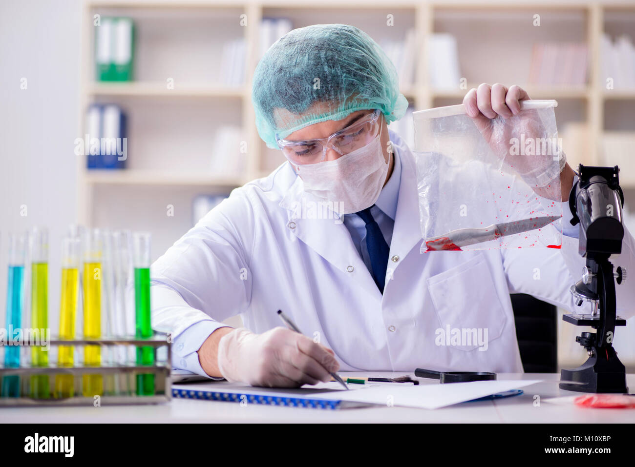 Forensics investigator working in lab on crime evidence Stock Photo - Alamy