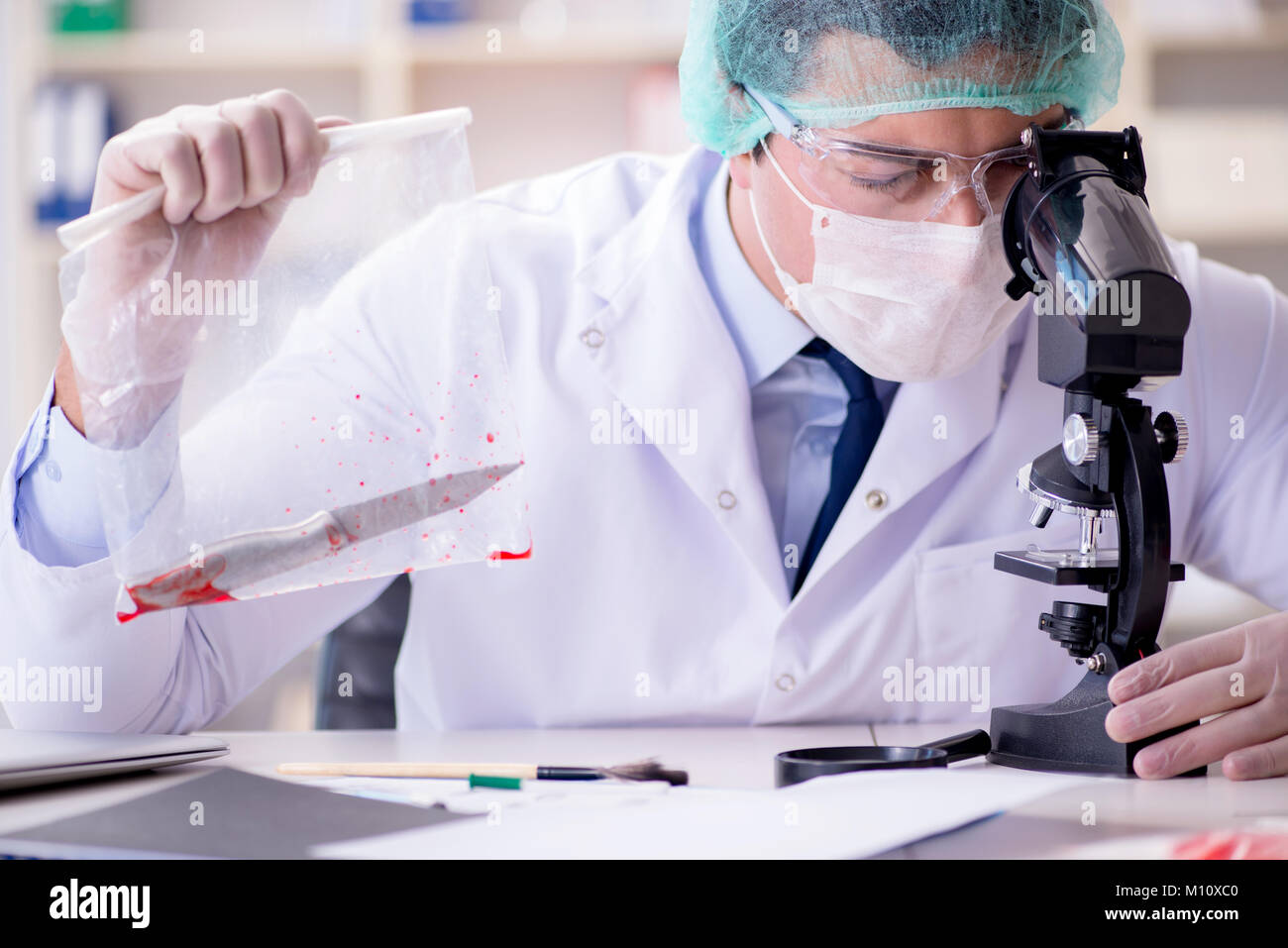 Forensics investigator working in lab on crime evidence Stock Photo - Alamy