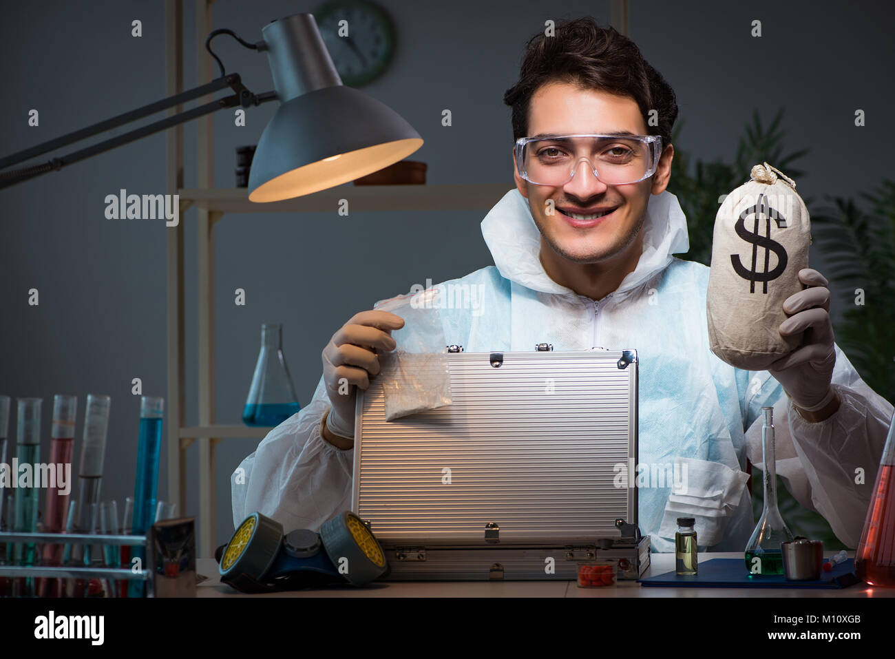 Forensic investigator working in lab looking for evidence Stock Photo ...