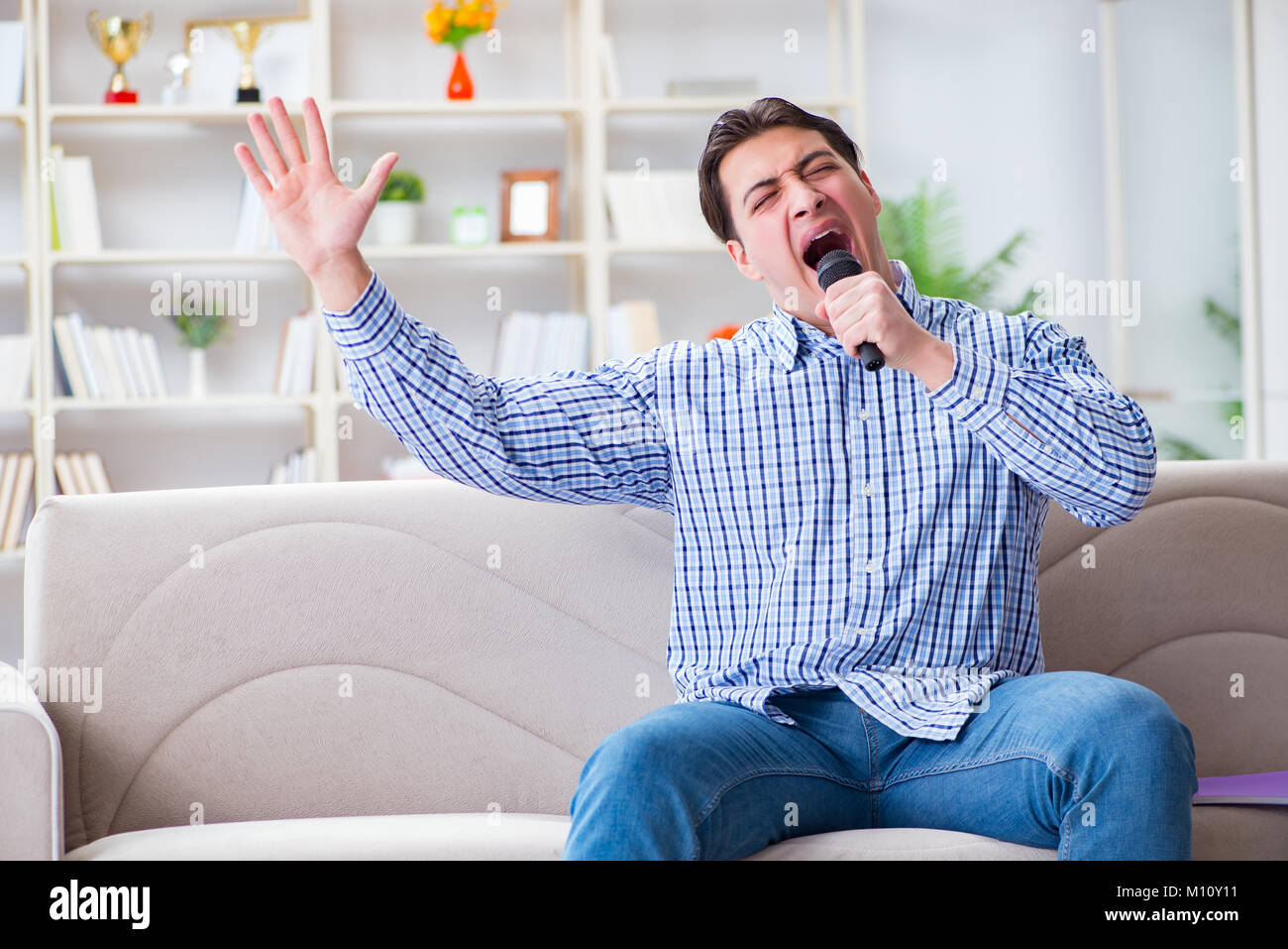 Funny man singing songs in karaoke at home Stock Photo - Alamy