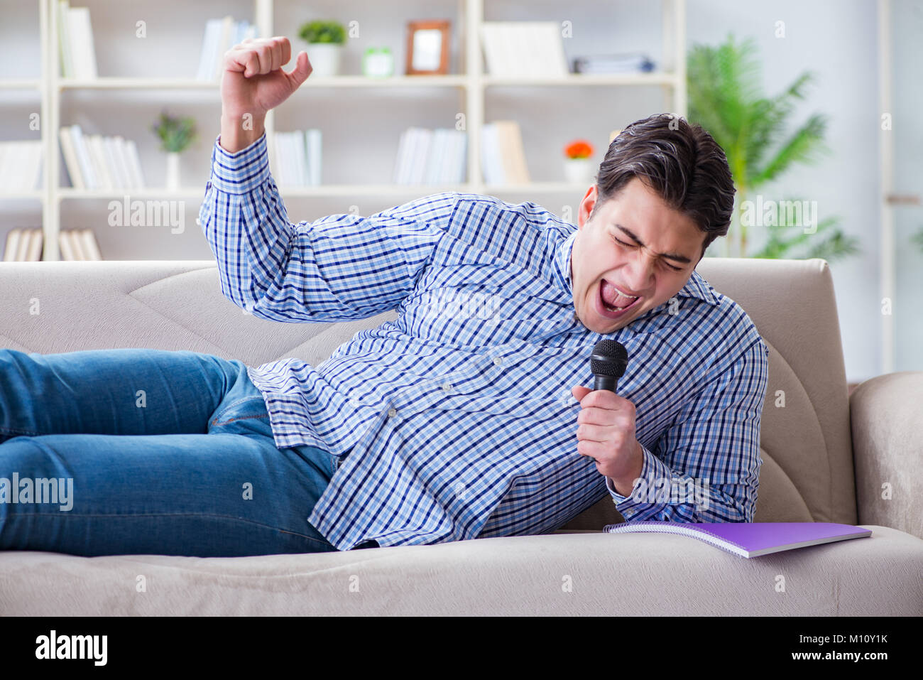 Funny man singing songs in karaoke at home Stock Photo - Alamy