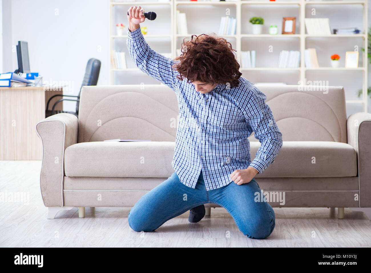 Funny man singing songs in karaoke at home Stock Photo - Alamy