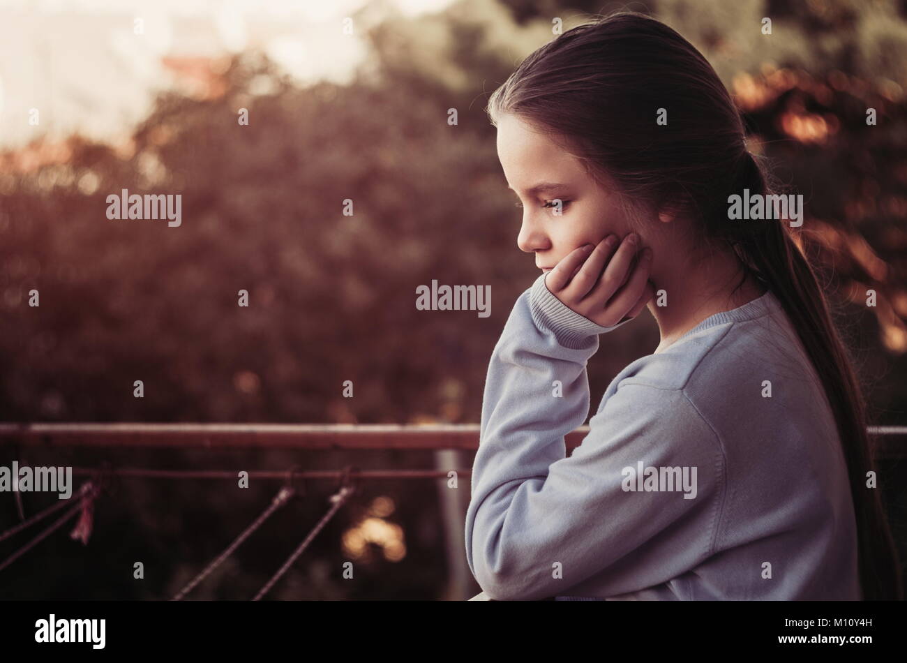 Girl thinking portrait on balcony. autumn time Stock Photo - Alamy