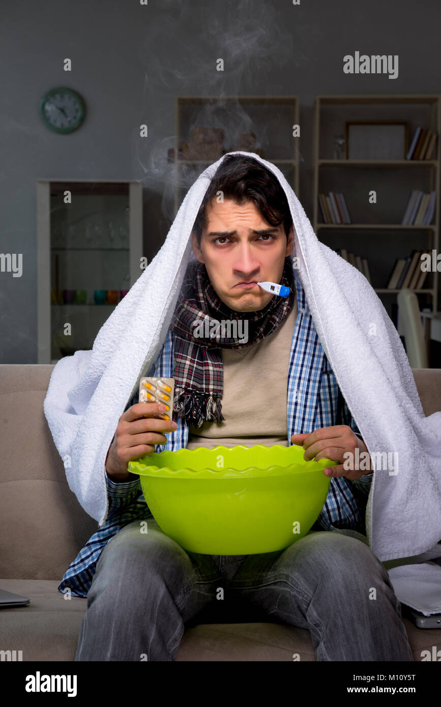 Sick man doing inhalation at night in home Stock Photo - Alamy