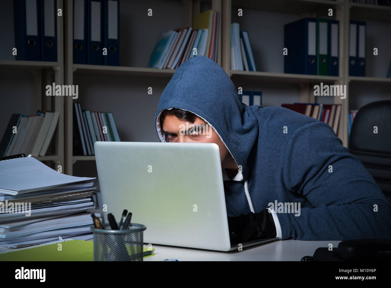 Young hacker hacking into computer at night Stock Photo - Alamy