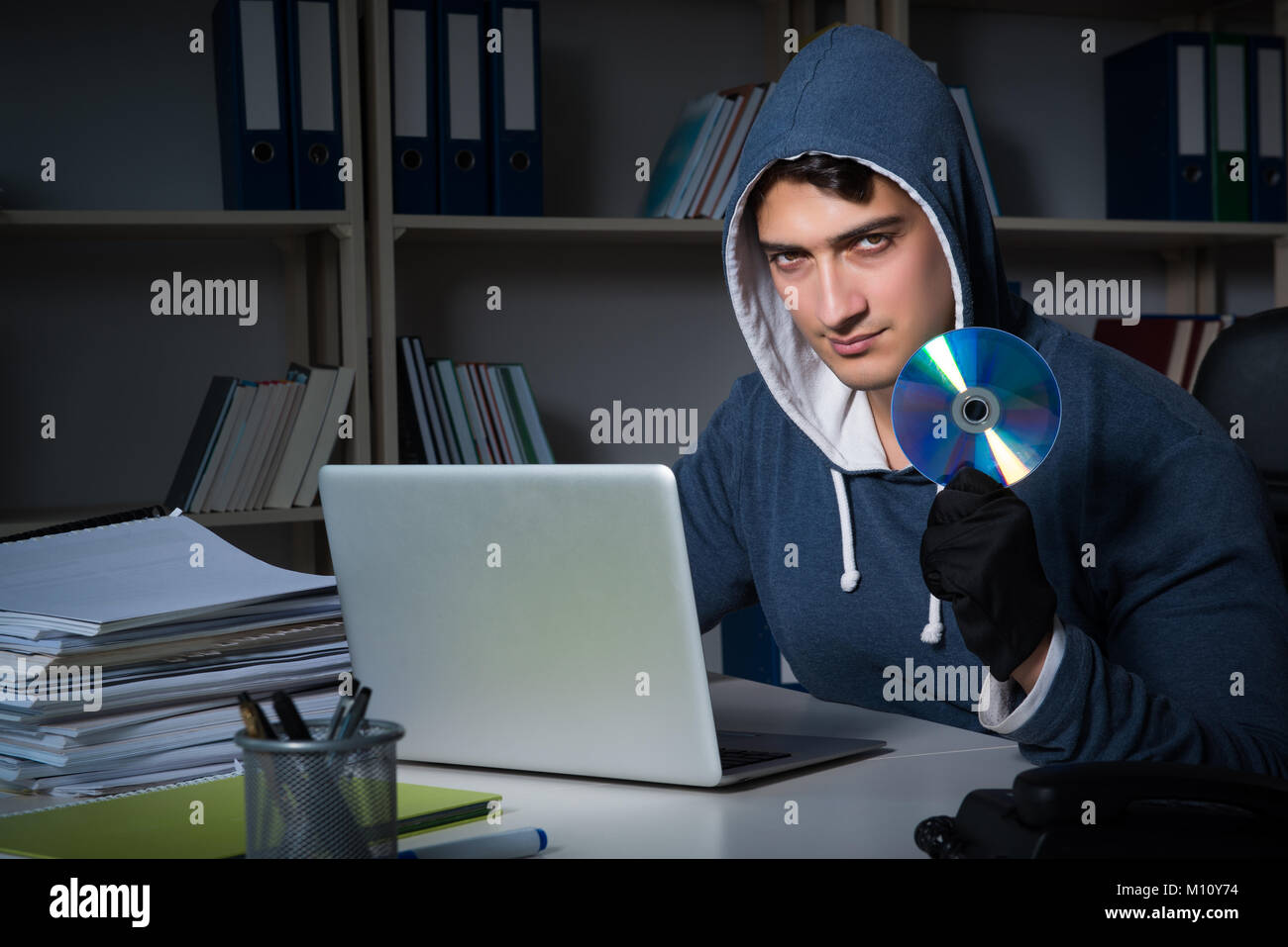 Young hacker hacking into computer at night Stock Photo - Alamy