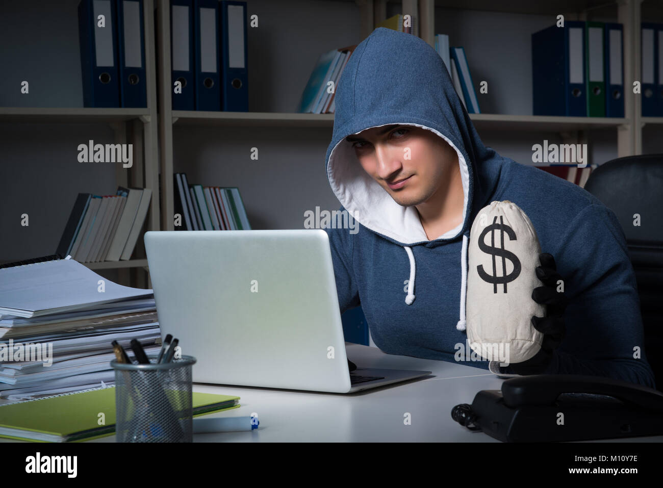 Young hacker hacking into computer at night Stock Photo - Alamy