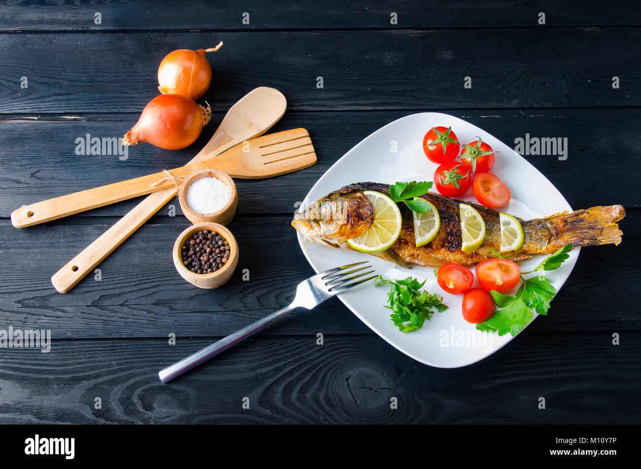 Fried fish served on the plate Stock Photo - Alamy