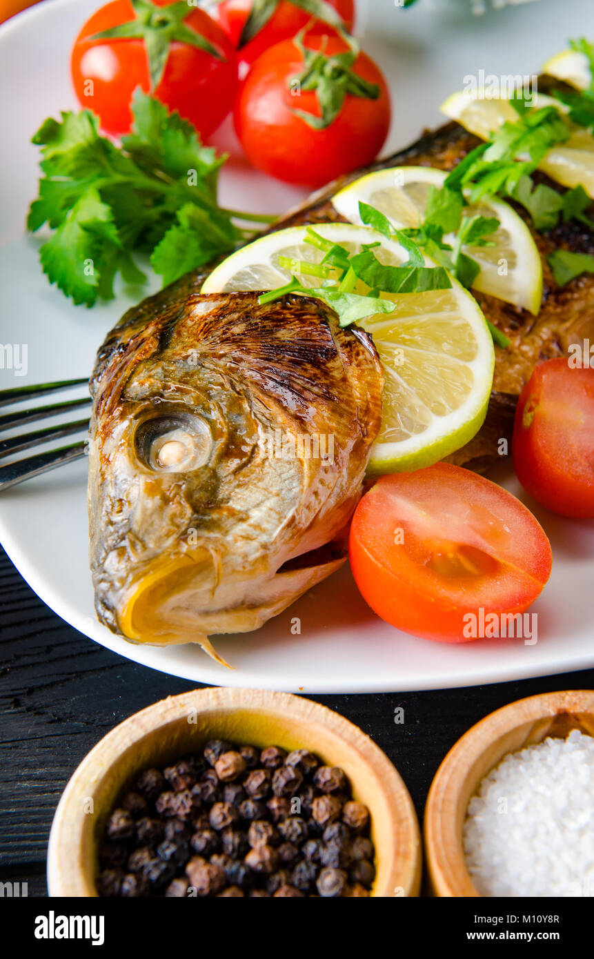 Fried fish served on the plate Stock Photo - Alamy