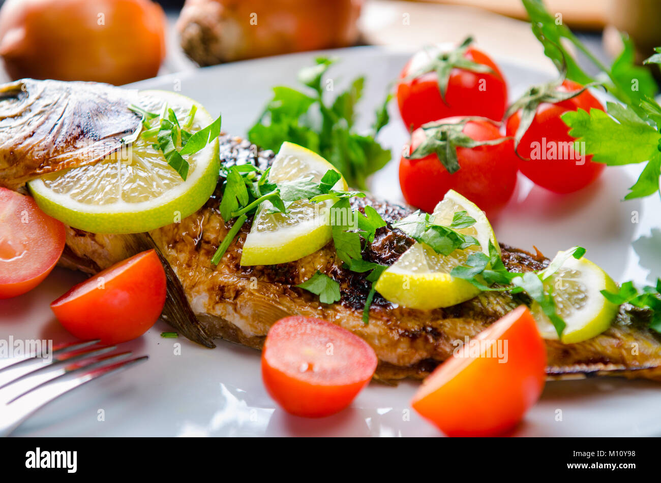 Fried fish served on the plate Stock Photo - Alamy