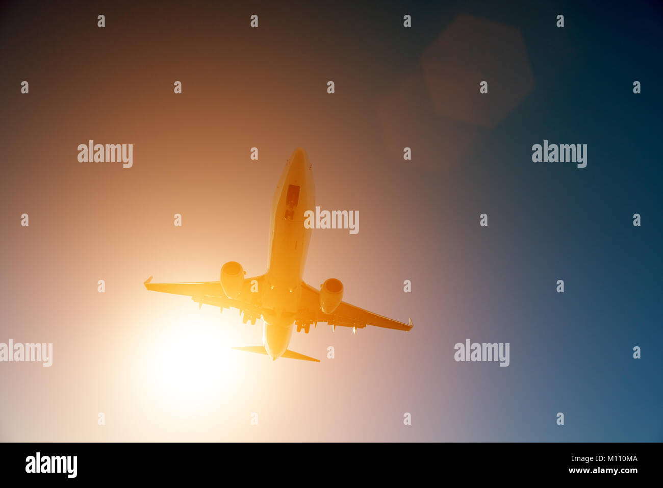 airplane in front of bright sunlight Stock Photo - Alamy
