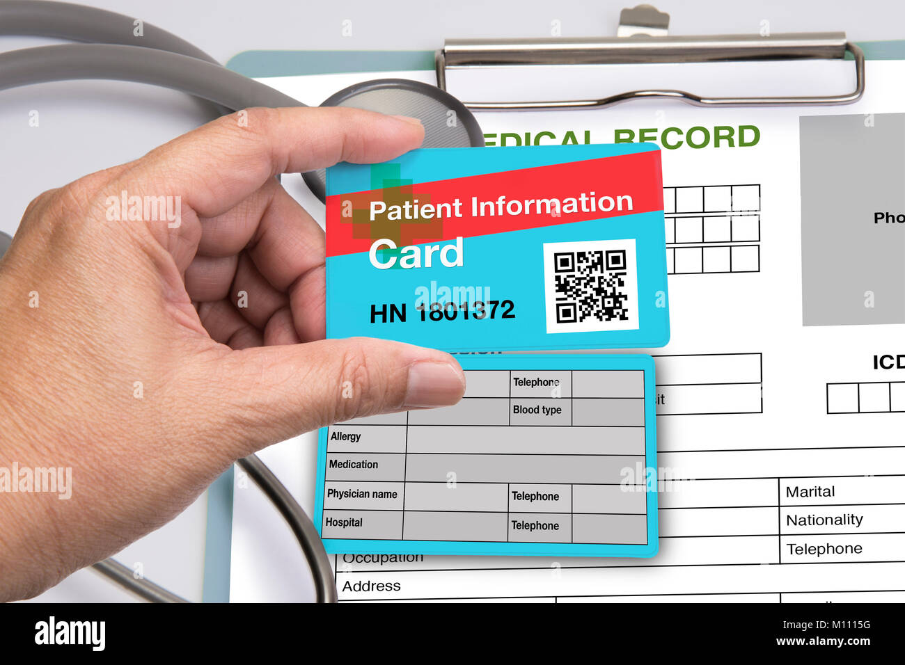 Someone holding blue patient information card in hand with blank ...