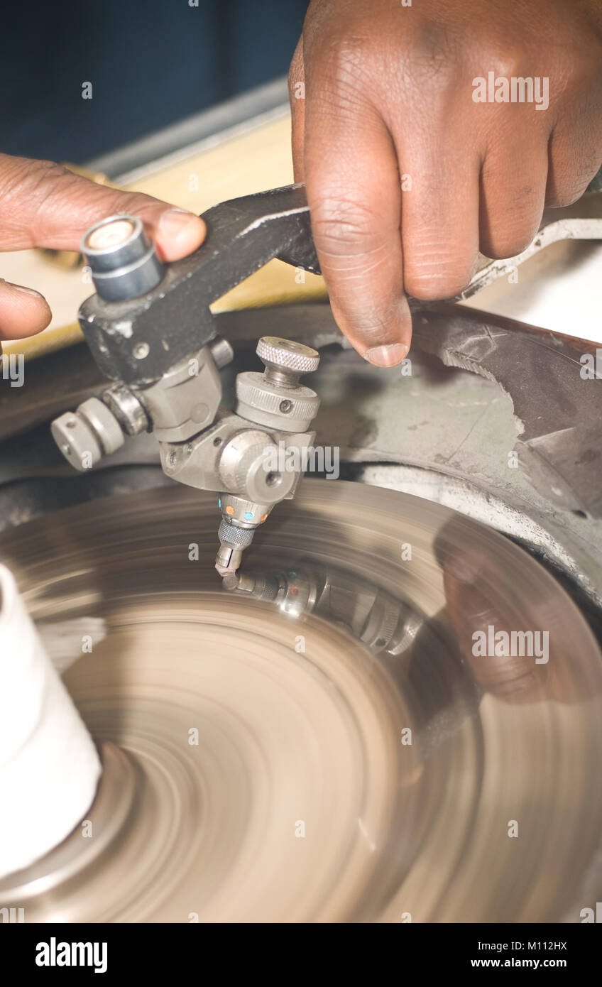 Diamond cutter hands during facetting of gemstone Stock Photo - Alamy