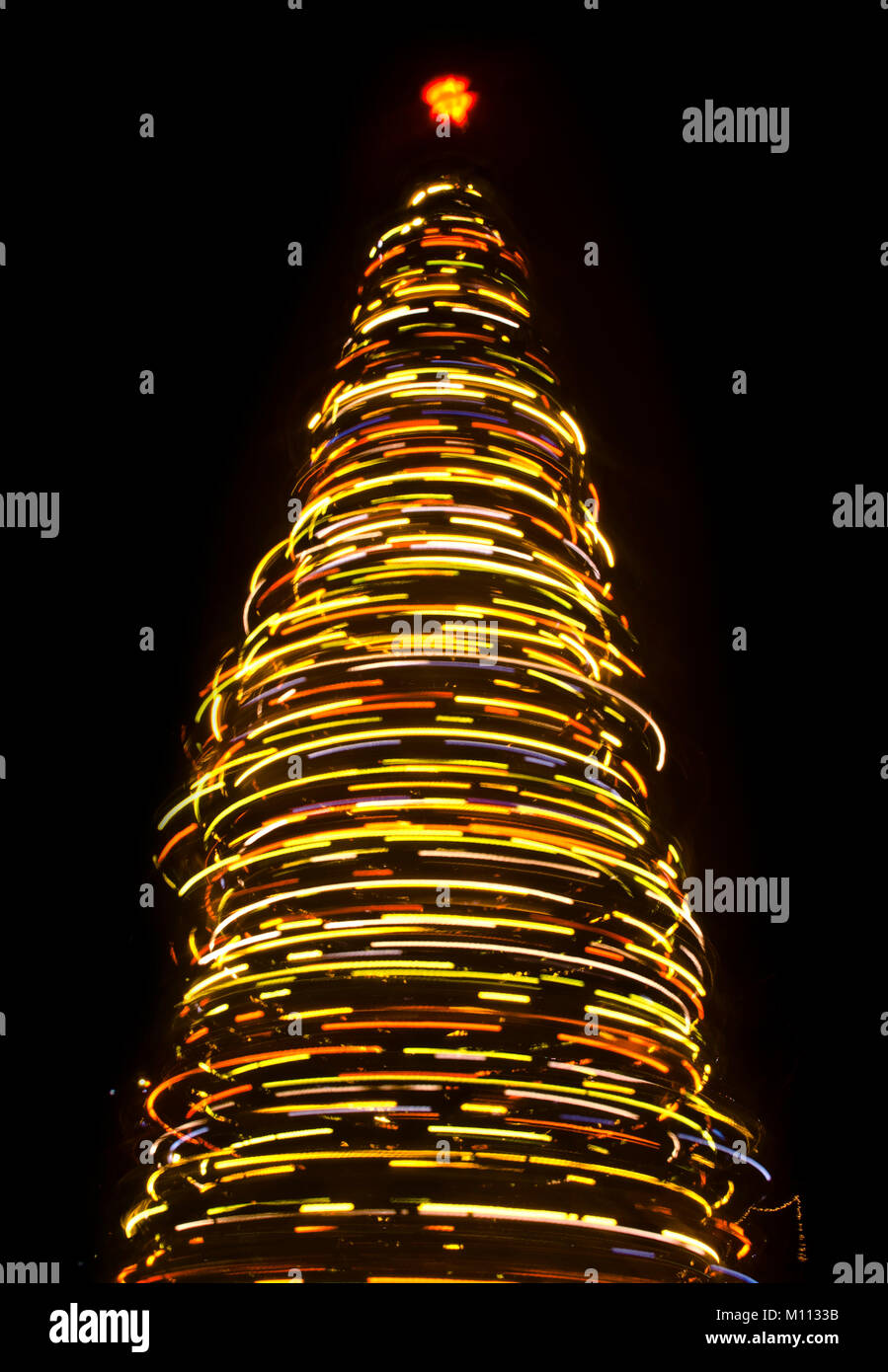 Blurred rotating Christmas tree at night over black Stock Photo - Alamy
