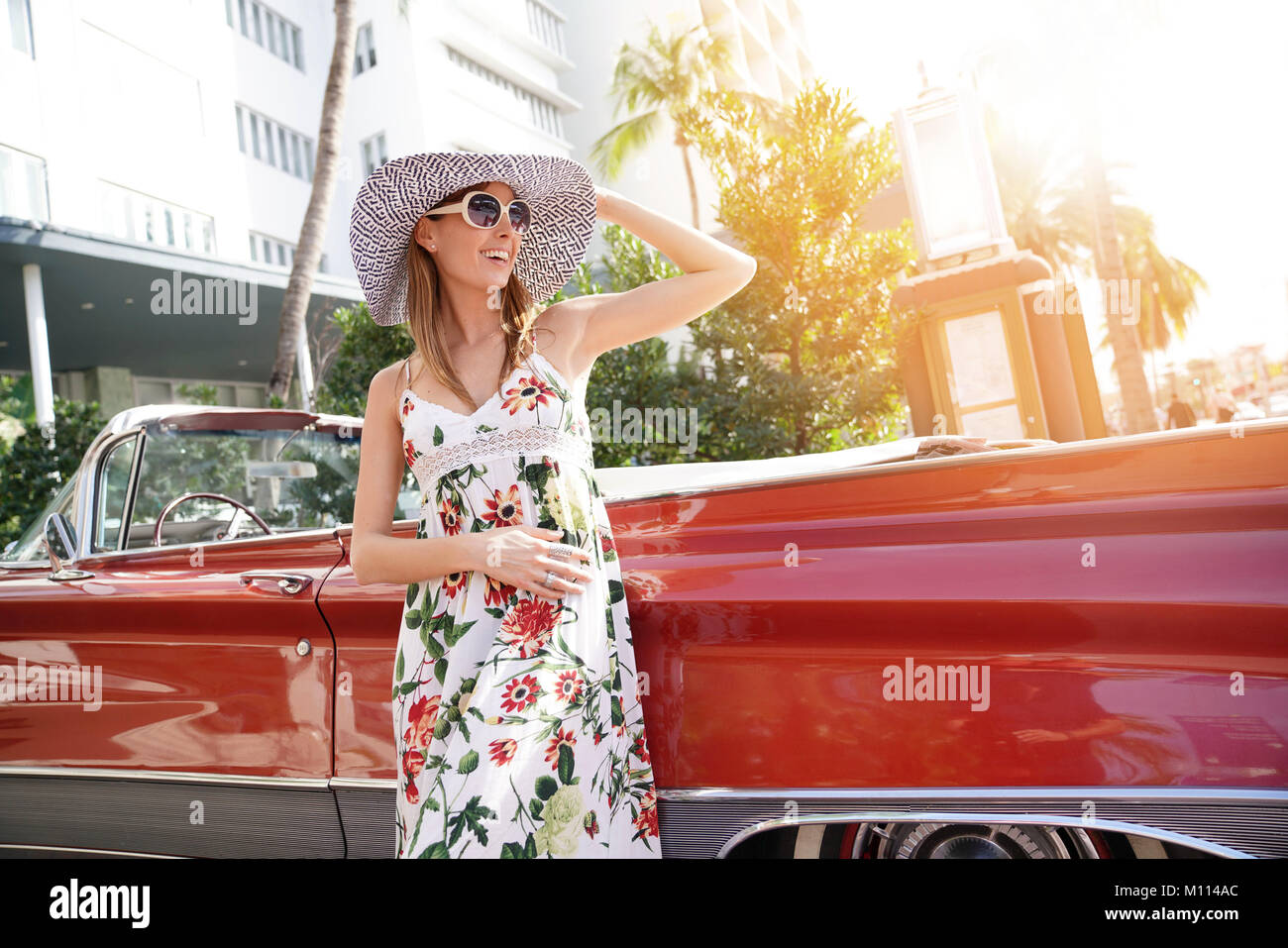 Model posing by old-fashioned car Stock Photo - Alamy