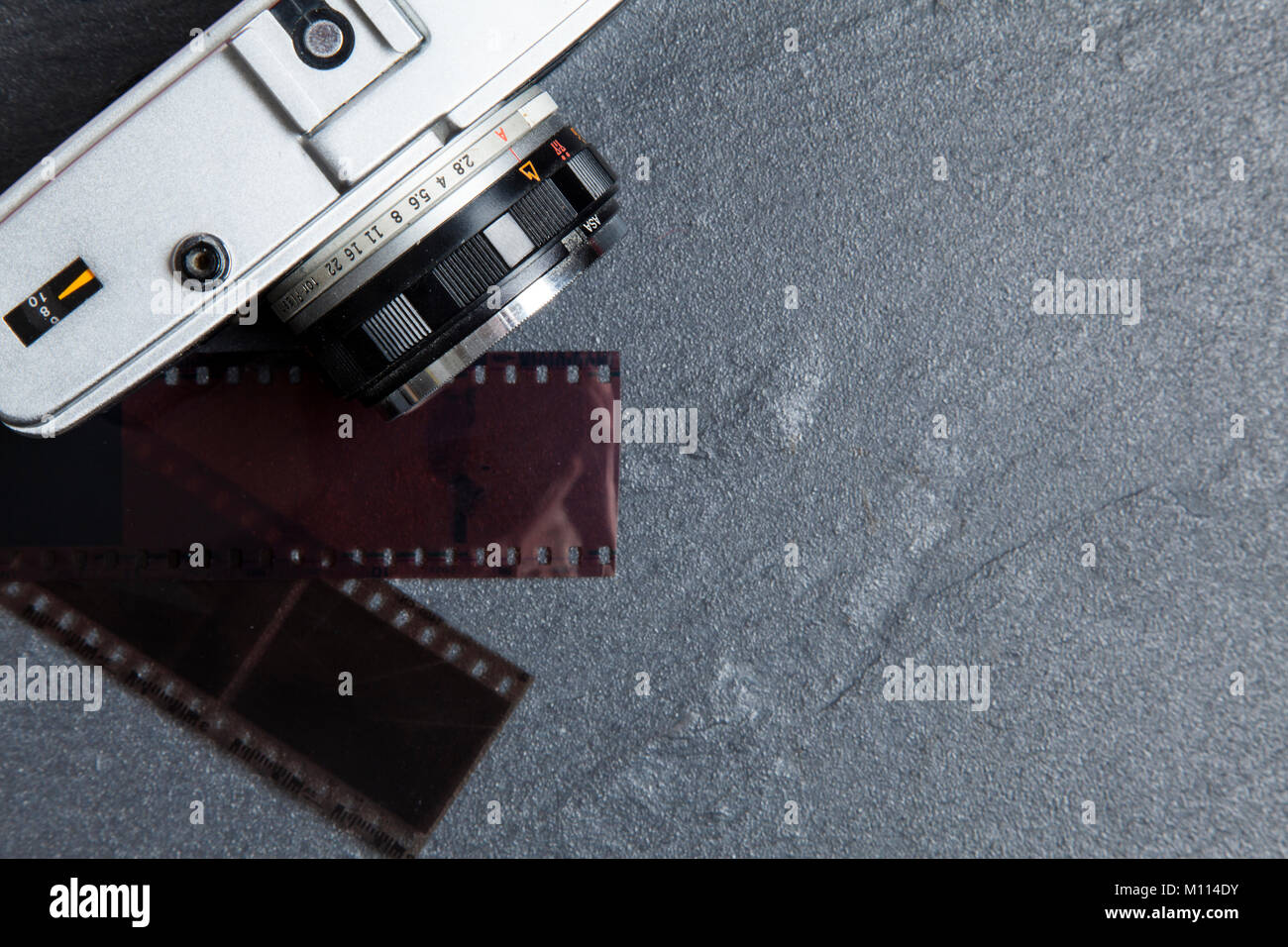 Vintage camera and film negatives on a slate background Stock Photo - Alamy