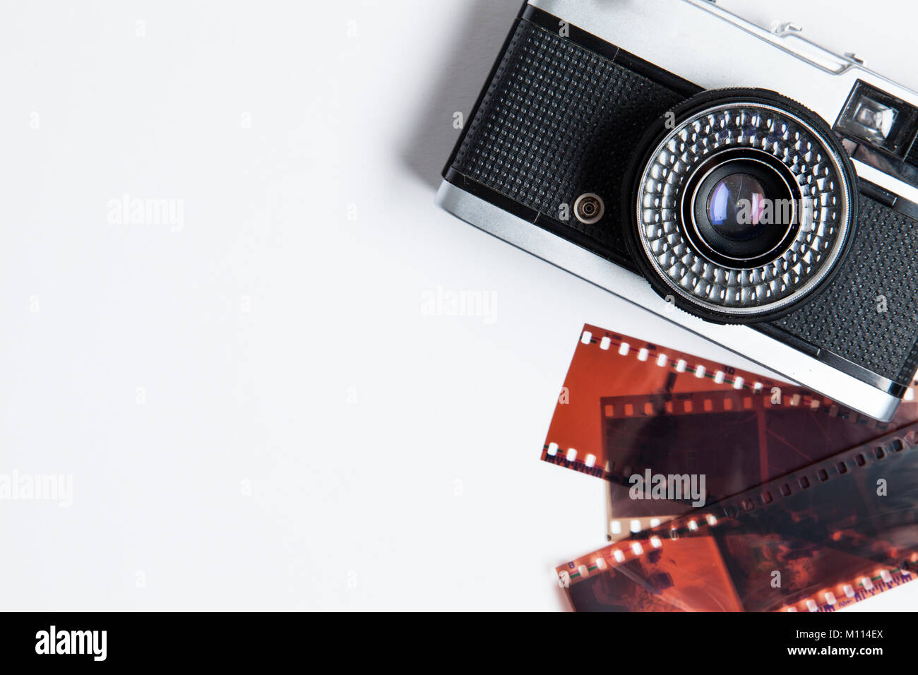Vintage film camera and negatives on a white background Stock Photo - Alamy