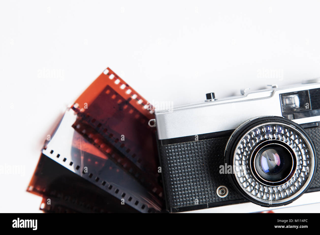 Vintage film camera and negatives on a white background Stock Photo - Alamy