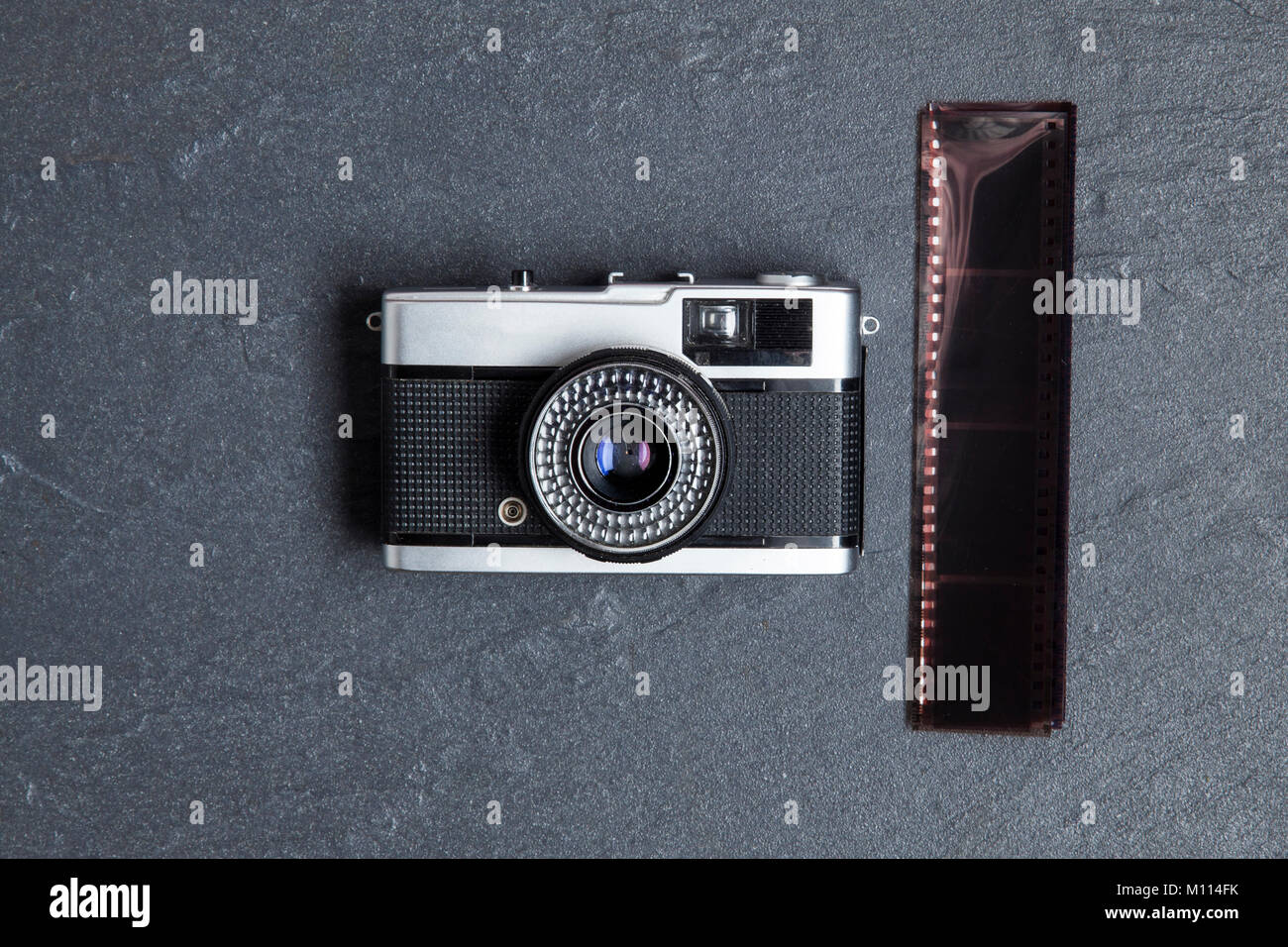 Vintage camera and film negatives on a slate background Stock Photo - Alamy