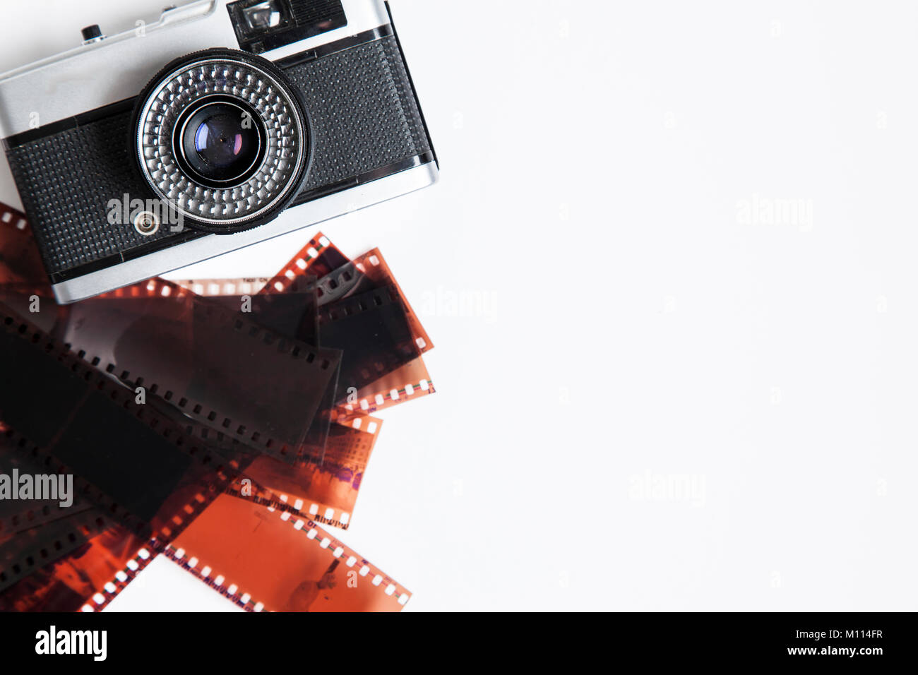 Vintage film camera and negatives on a white background Stock Photo - Alamy
