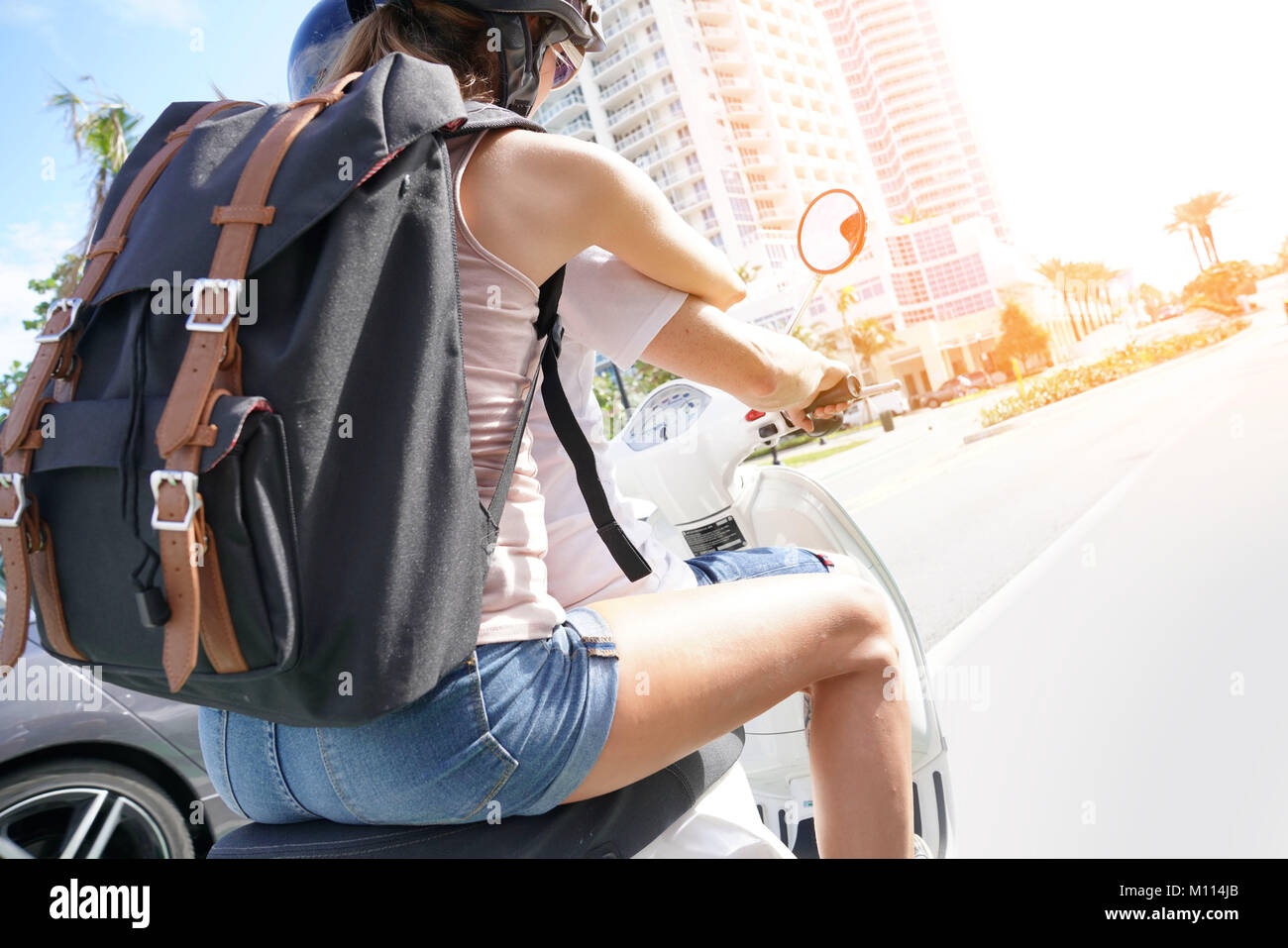 Back view of girl riding scooter with boyfriend in Miami Stock Photo ...