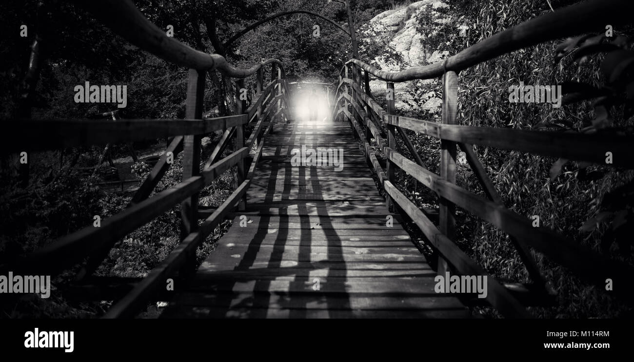 abstract spooky wooden bridge with man silhouette in black and white ...