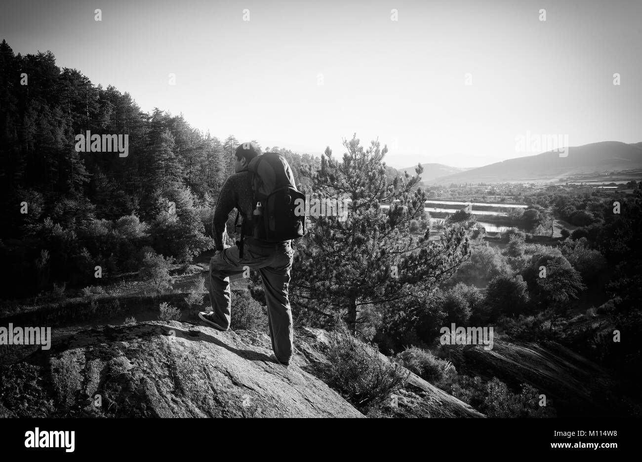 black and white landscape with man on rocky clift Stock Photo - Alamy