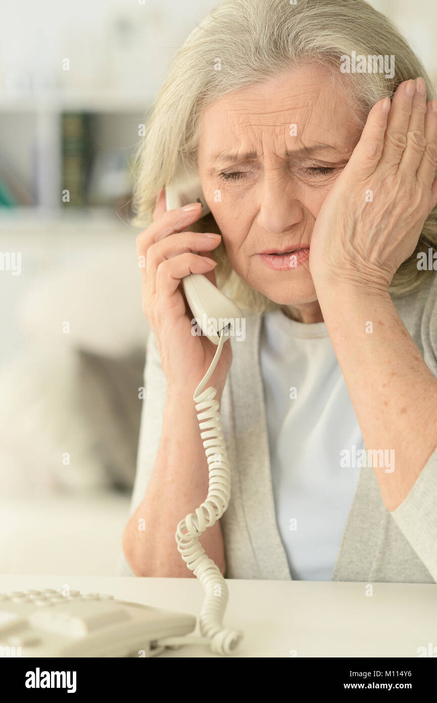Mature woman telephone unhappy hi-res stock photography and images - Alamy