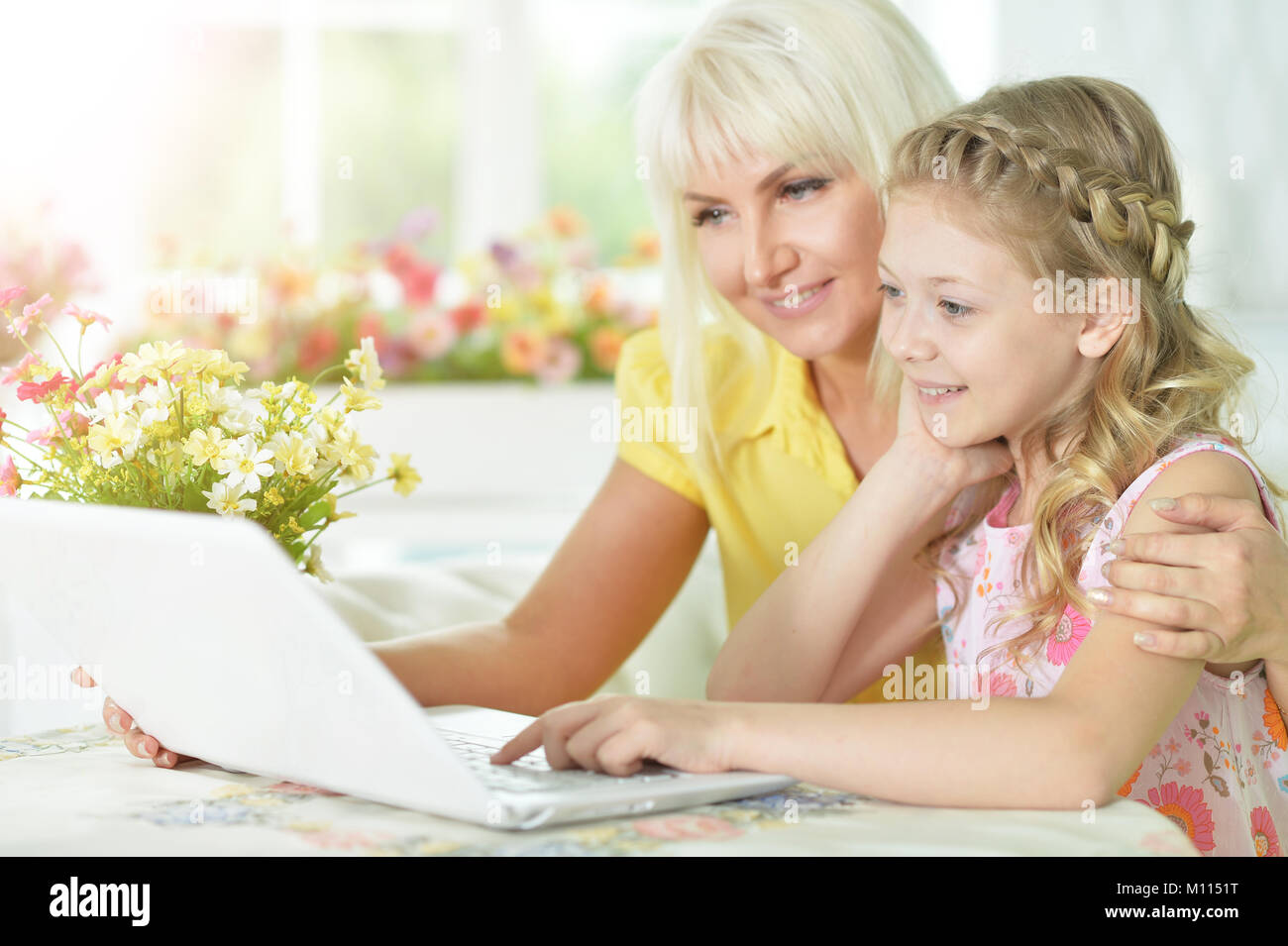 mother and daughter using laptop Stock Photo - Alamy