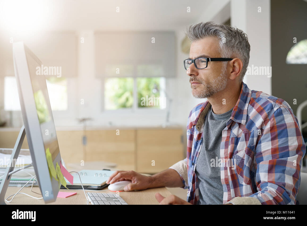 Web designer working in office on desktop computer Stock Photo - Alamy