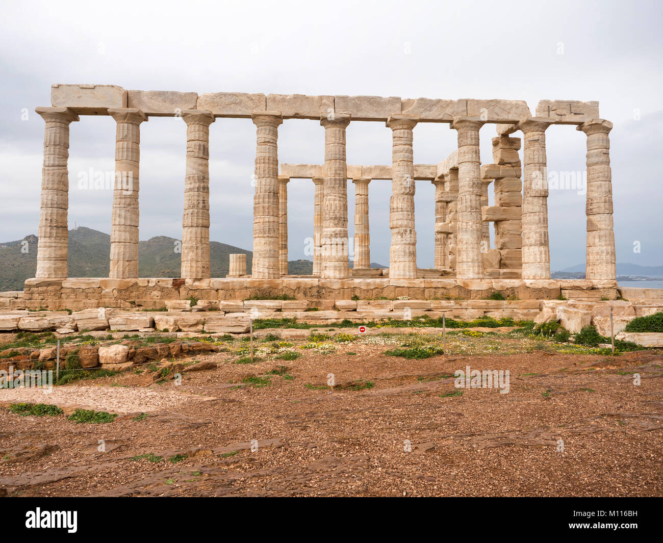 Ruins of an ancient Greek temple of Poseidon under dramatic cloudy sky ...