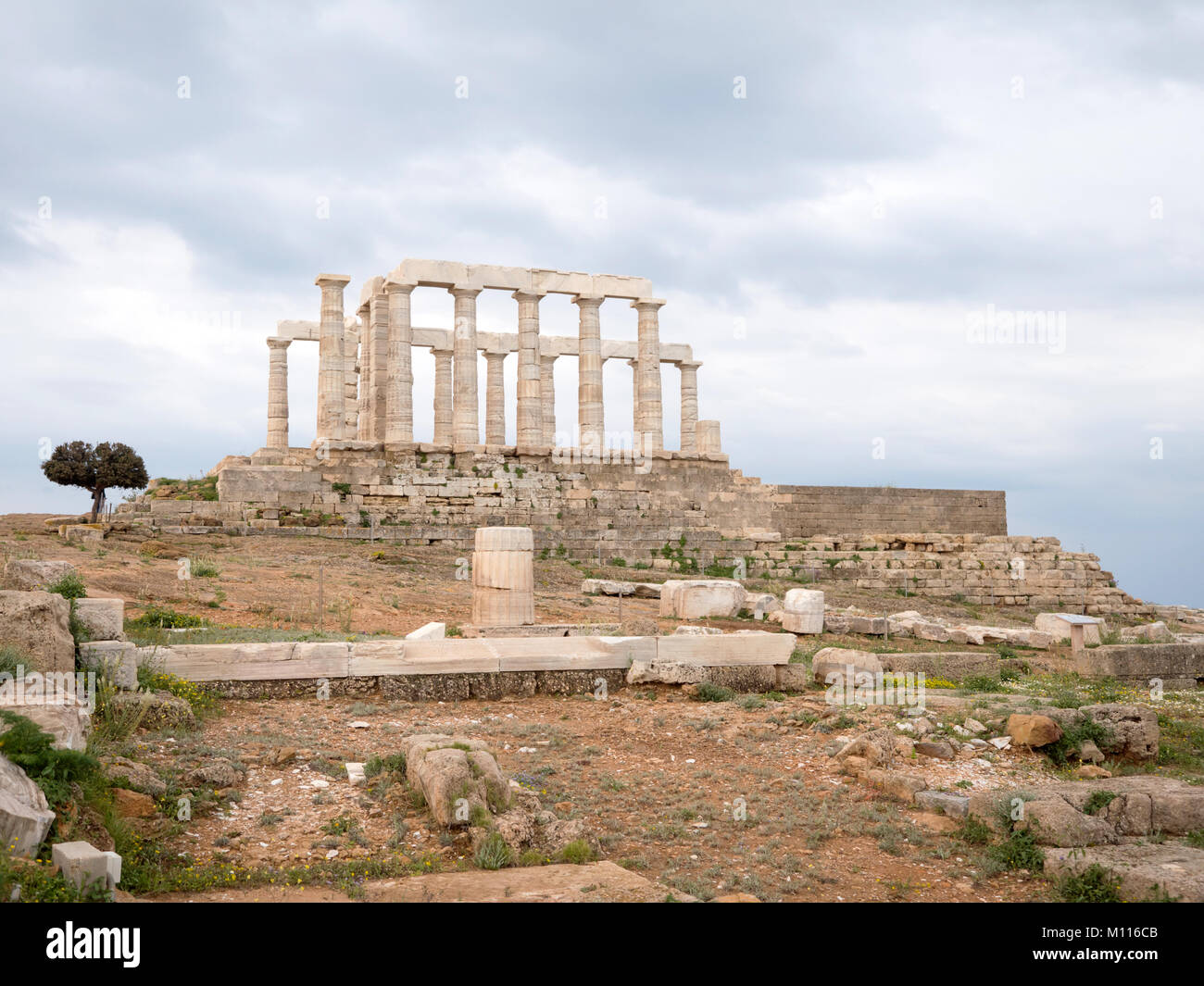 Ruins of an ancient Greek temple of Poseidon under dramatic cloudy sky ...