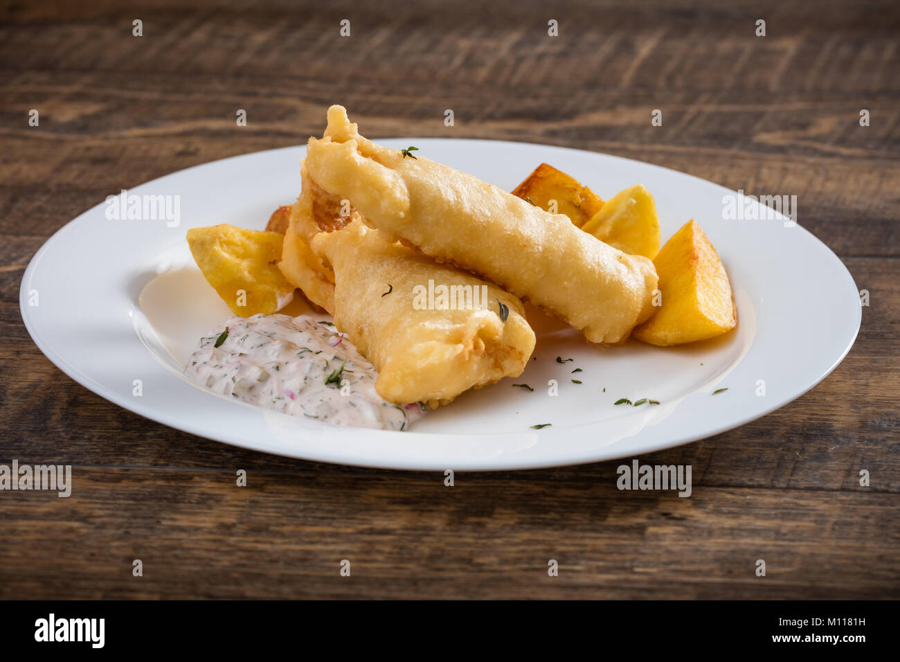 fried dorada fish with potatoes Stock Photo - Alamy