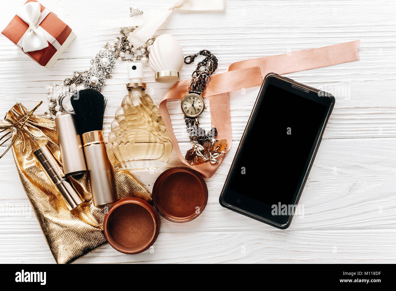smart phone with empty screen and luxury jewelry perfume presents make ...