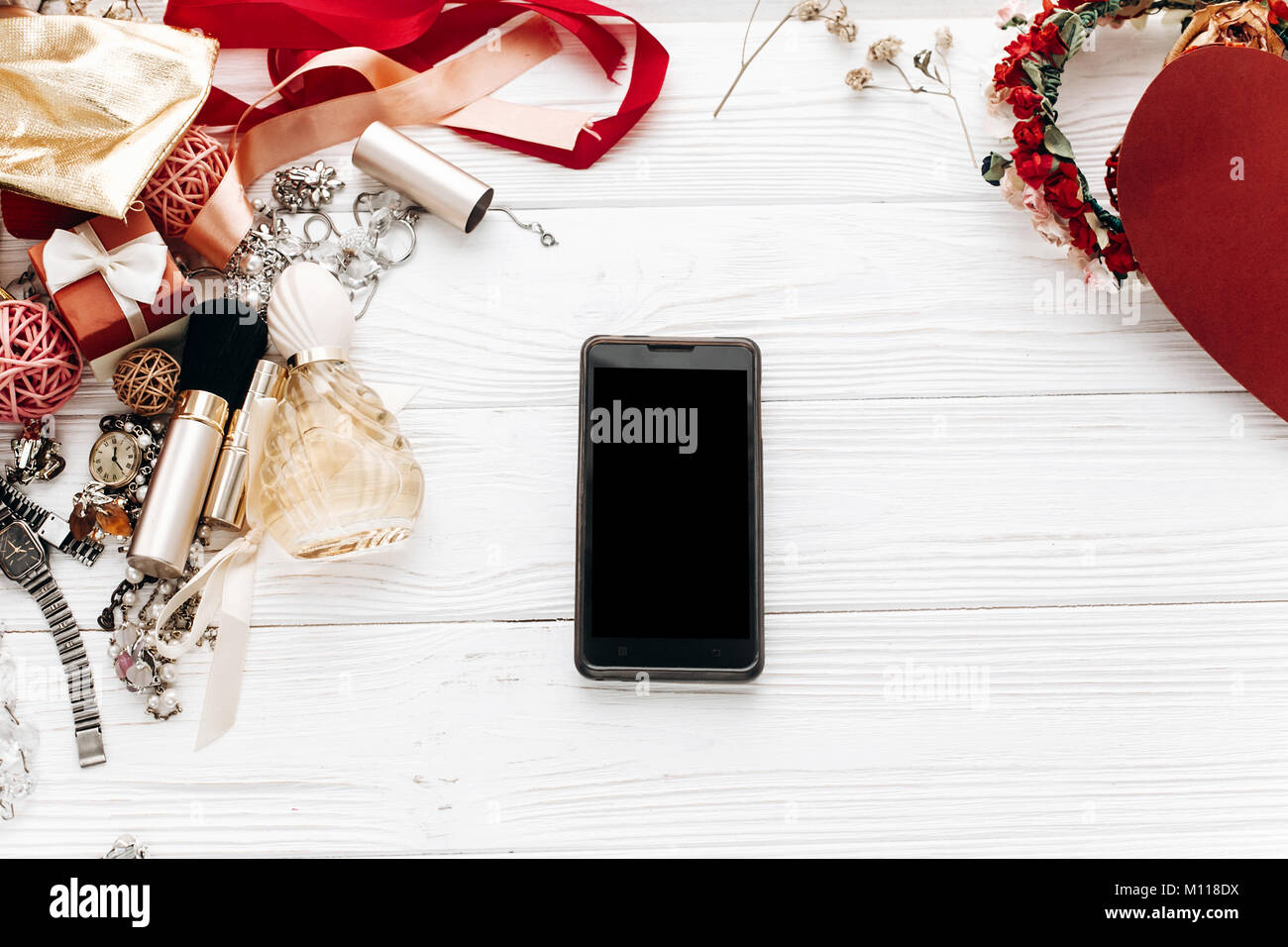 smart phone with empty screen and luxury essentials jewelry perfume ...