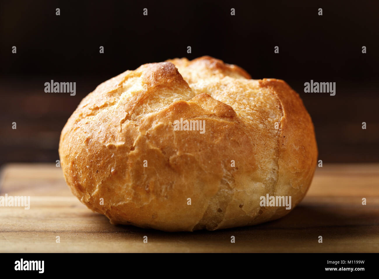 fresh crispy wheat rolls of white flour on a wooden background Stock ...
