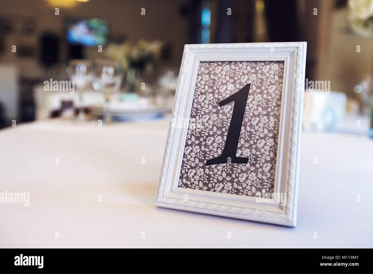 Wedding table with the sign number one Stock Photo - Alamy