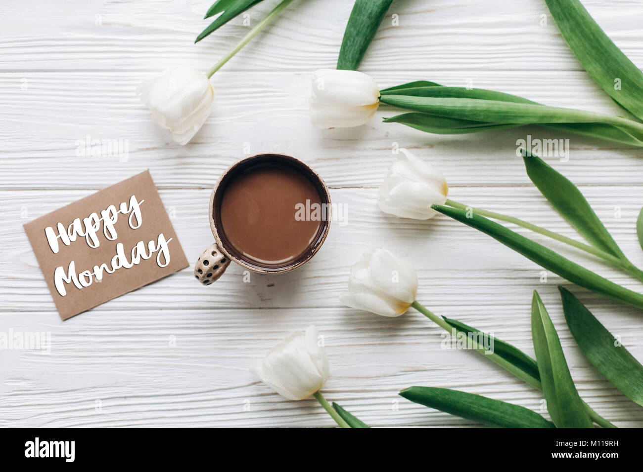 happy monday text sign on greeting card with tulips and morning coffee ...