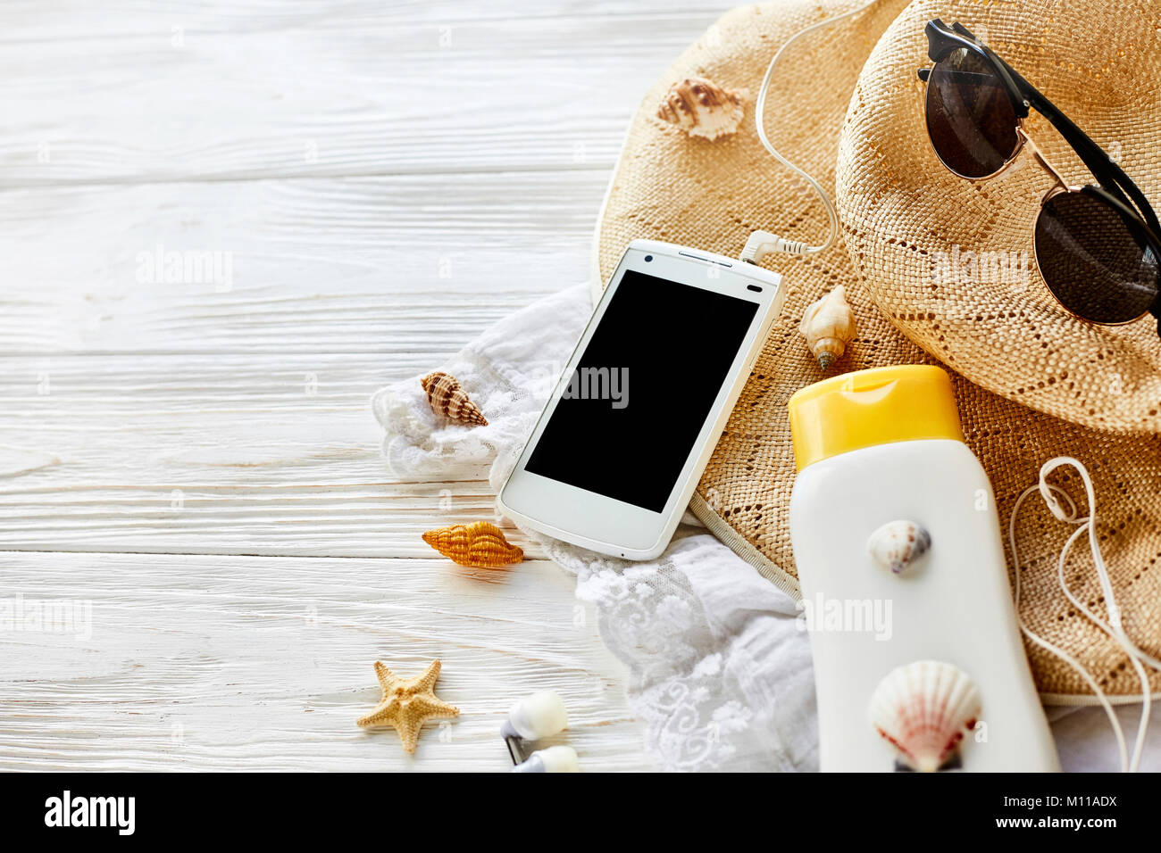 summer vacation concept flat lay. yellow hat, sunglasses phone ...