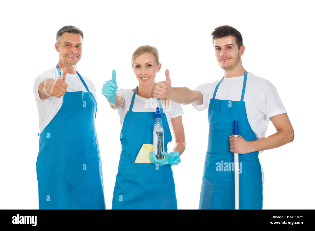 Portrait Of Happy Janitors Showing Thumb Up Sign Against White ...
